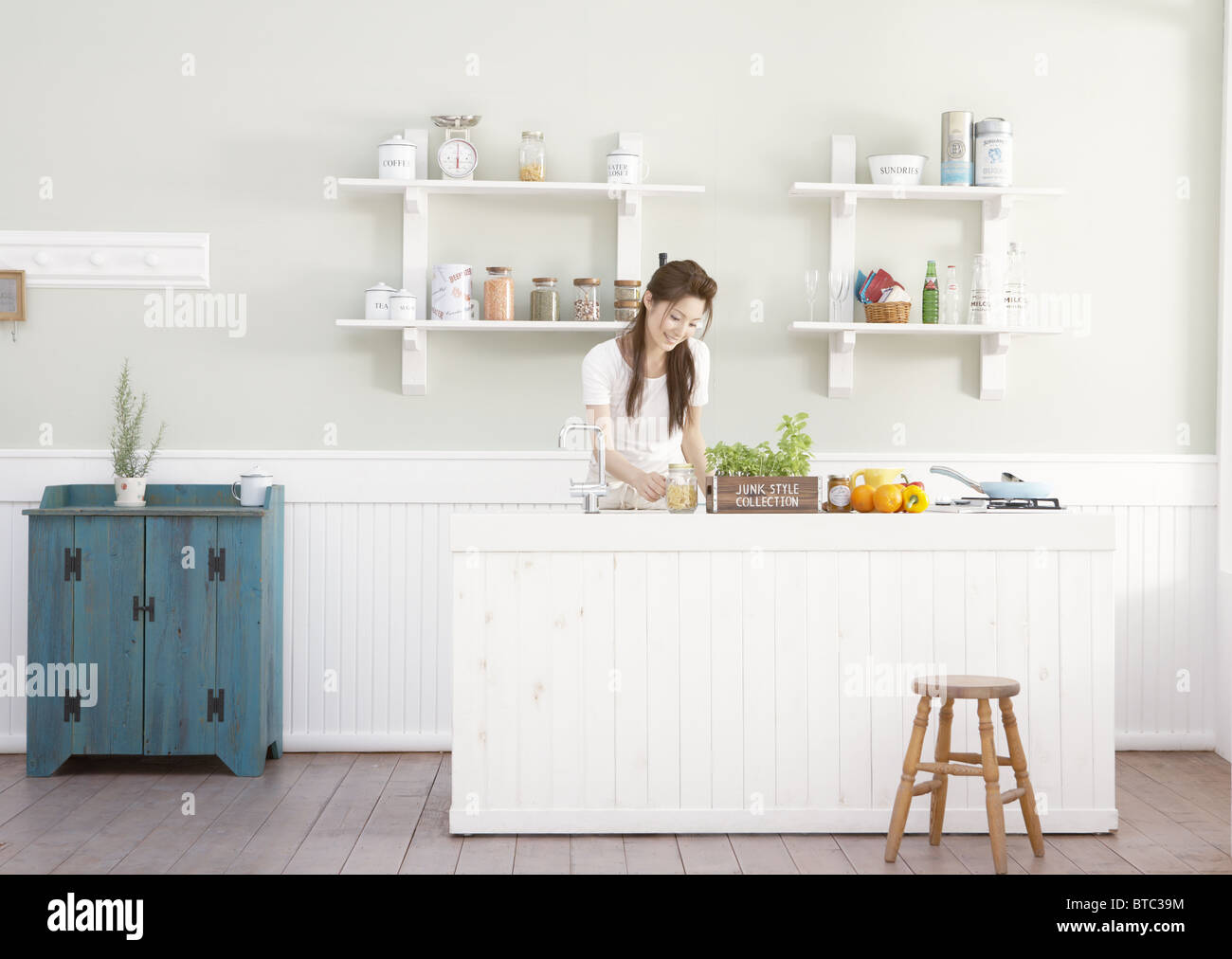 Woman standing kitchen stool hi-res stock photography and images - Alamy