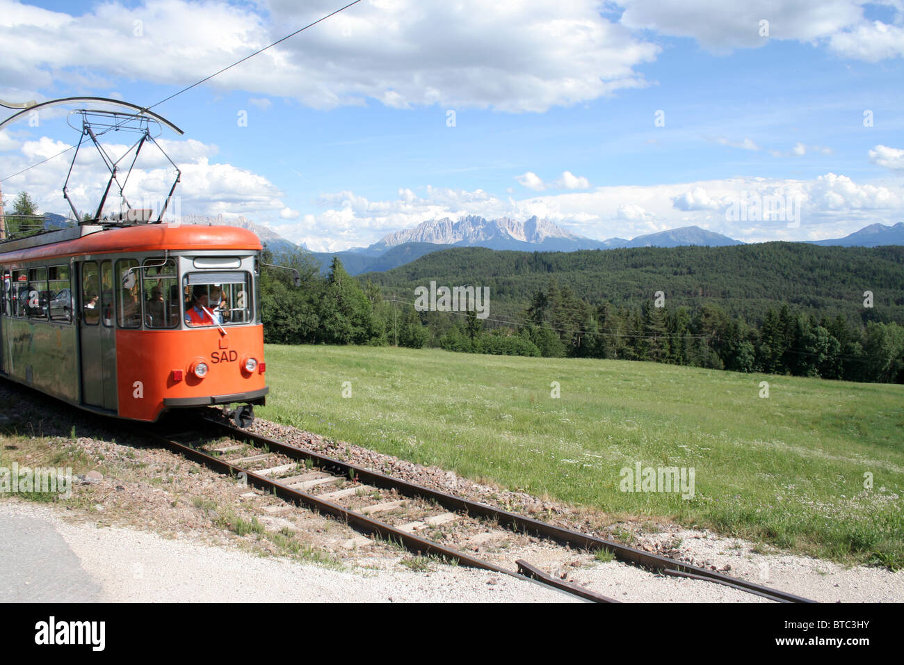 Train running along Renon plateau with Dolomites scenery Stock Photo ...