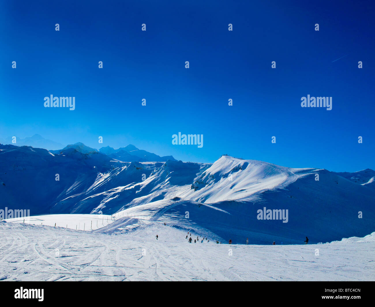 Flaine ski slopes with extensive powder snow and deep blue sky ...
