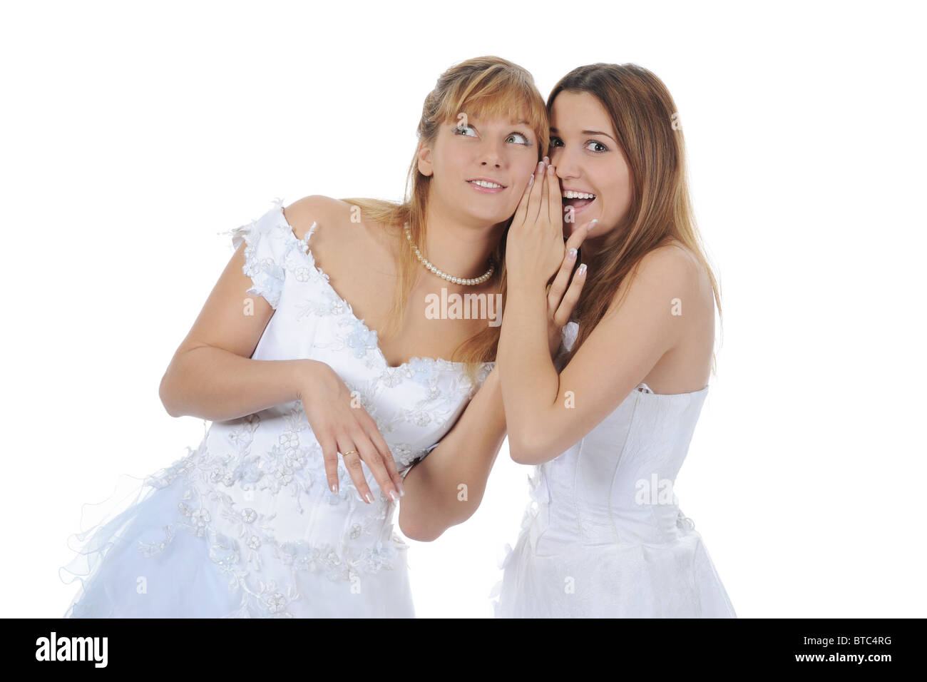 Two beautiful women telling secret Stock Photo - Alamy
