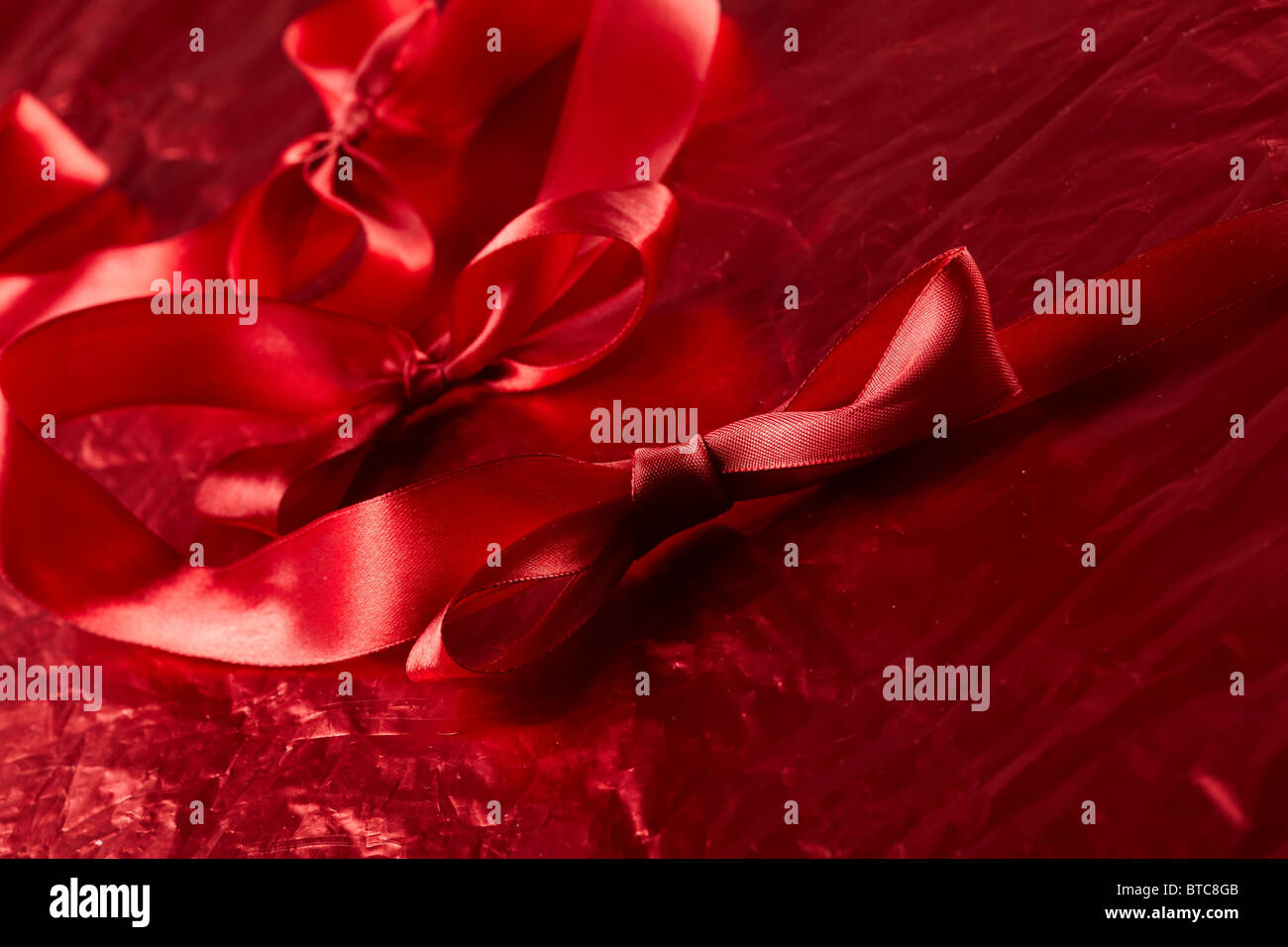 satin ribbons on the red background Stock Photo - Alamy
