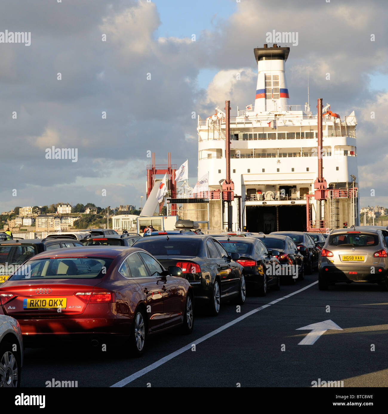 Queuing cars wait in line to board a cross channel ferry at St Malo ...