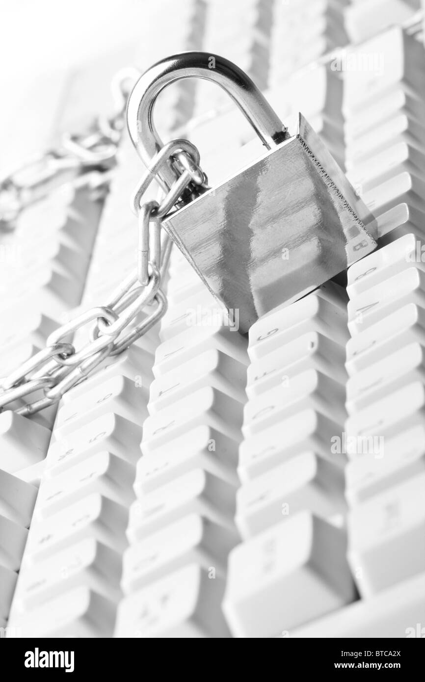 Computer keyboard secured with chain and padlock Stock Photo - Alamy