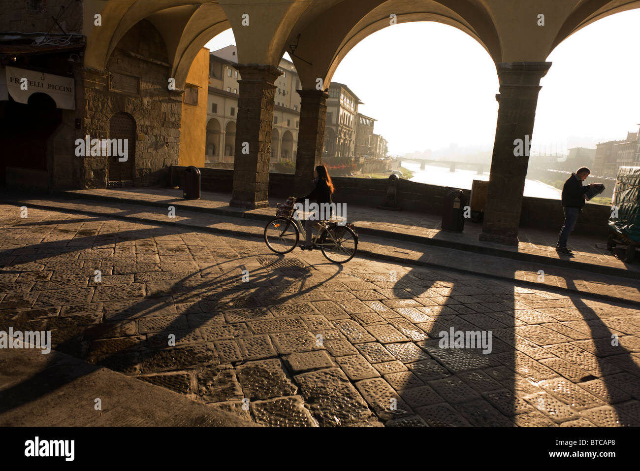 Italian commuters cross the central arches of the Ponte Vecchio over ...