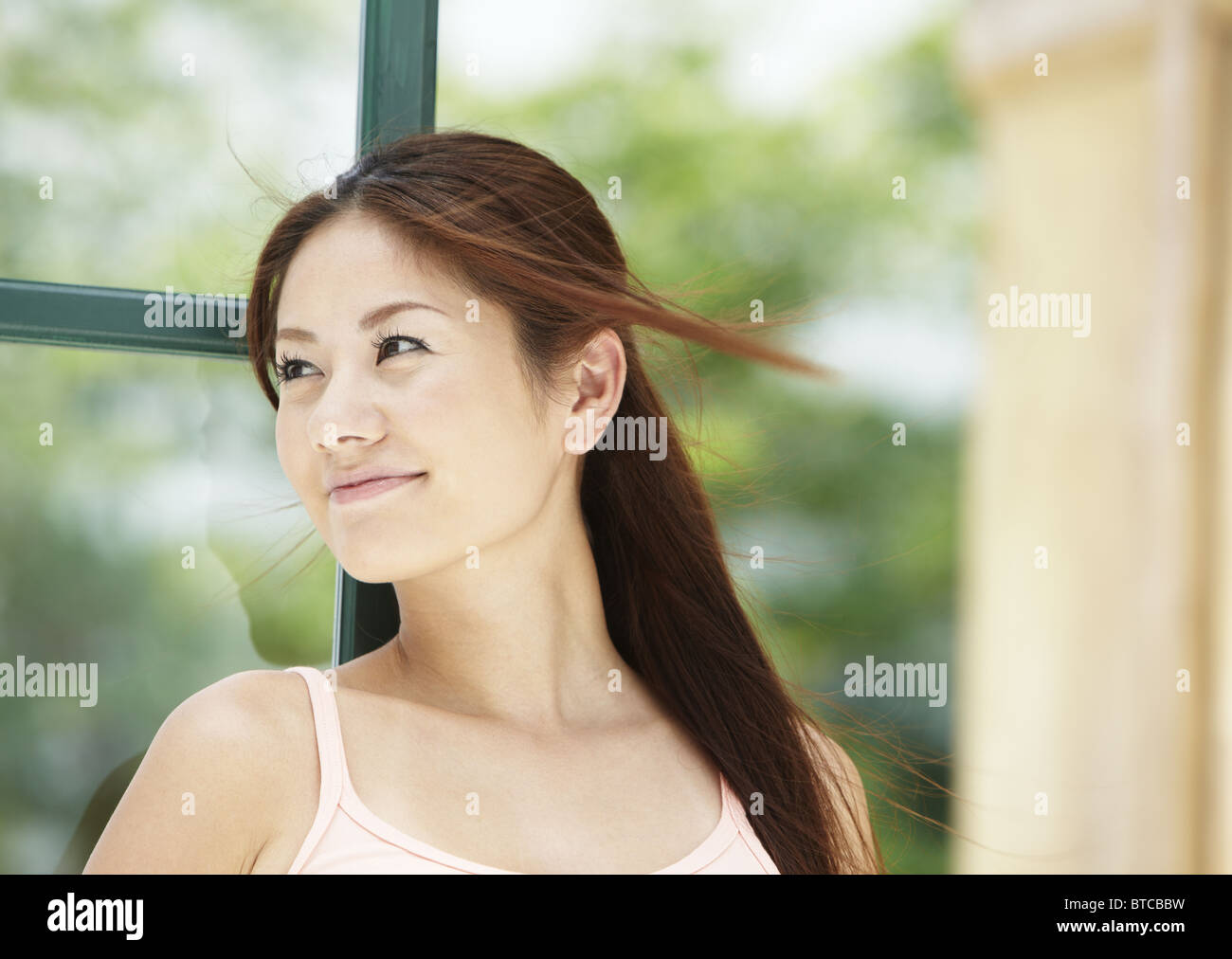Woman standing by window Stock Photo - Alamy