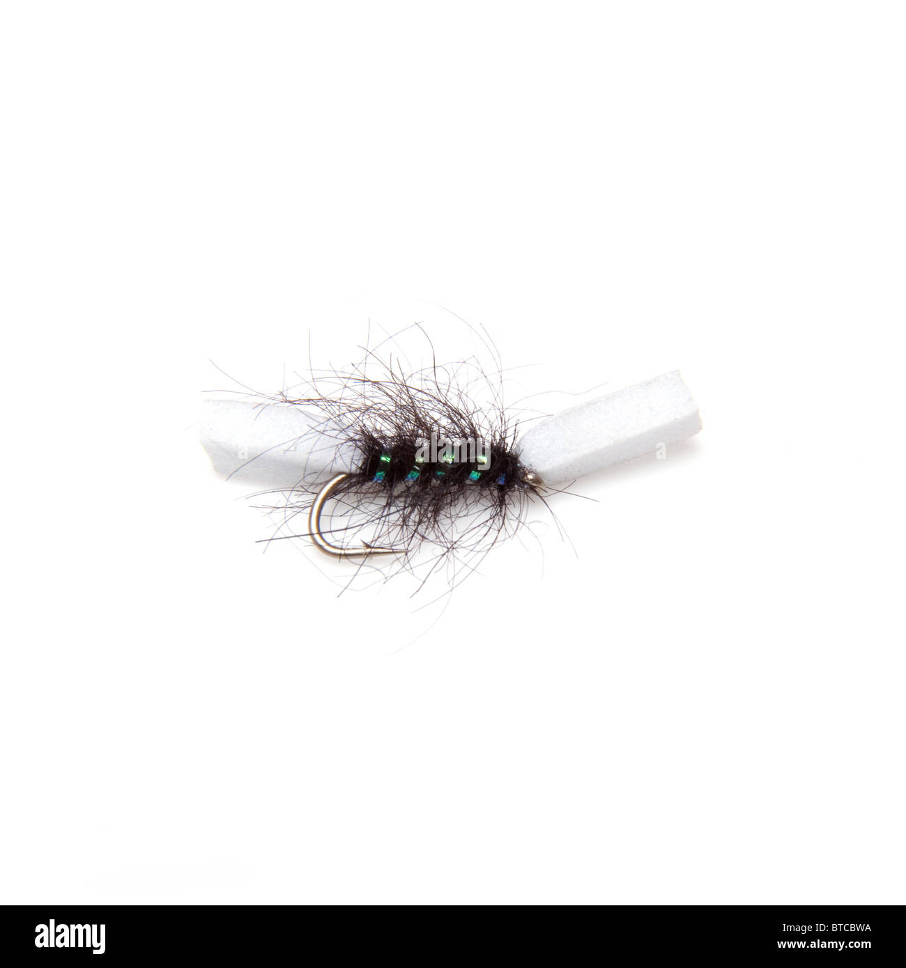 Sugar lump foam trout fly size 12 isolated on a white studio background ...
