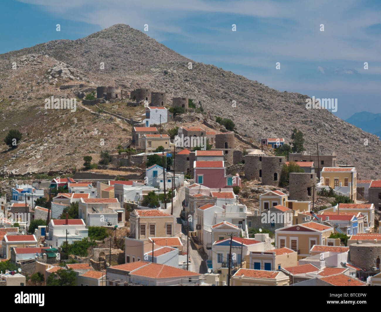 Row of old windmills along a hilltop on Symi island Stock Photo - Alamy
