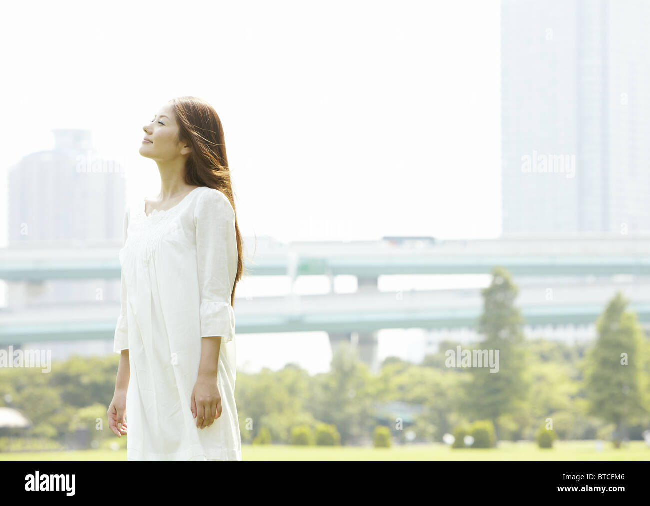 Young woman looking up Stock Photo - Alamy