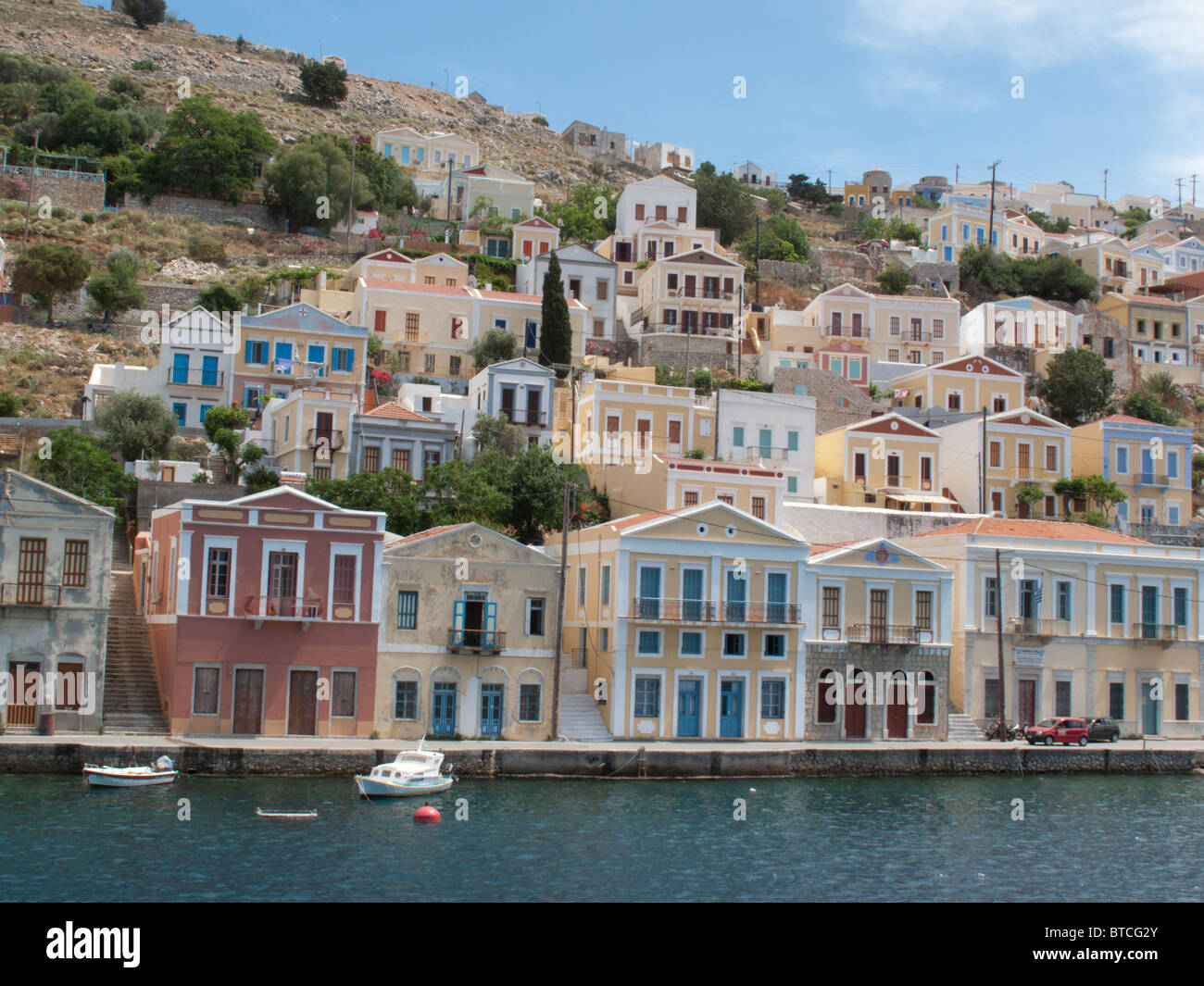 Typical Symi neo-classical houses on the harbour Stock Photo - Alamy