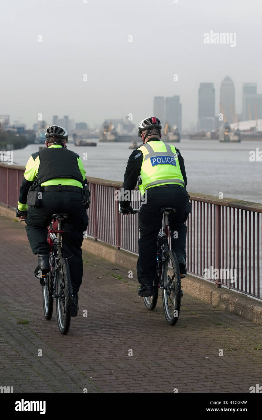 Metropolitan Police constables riding mountain bikes along the banks of ...