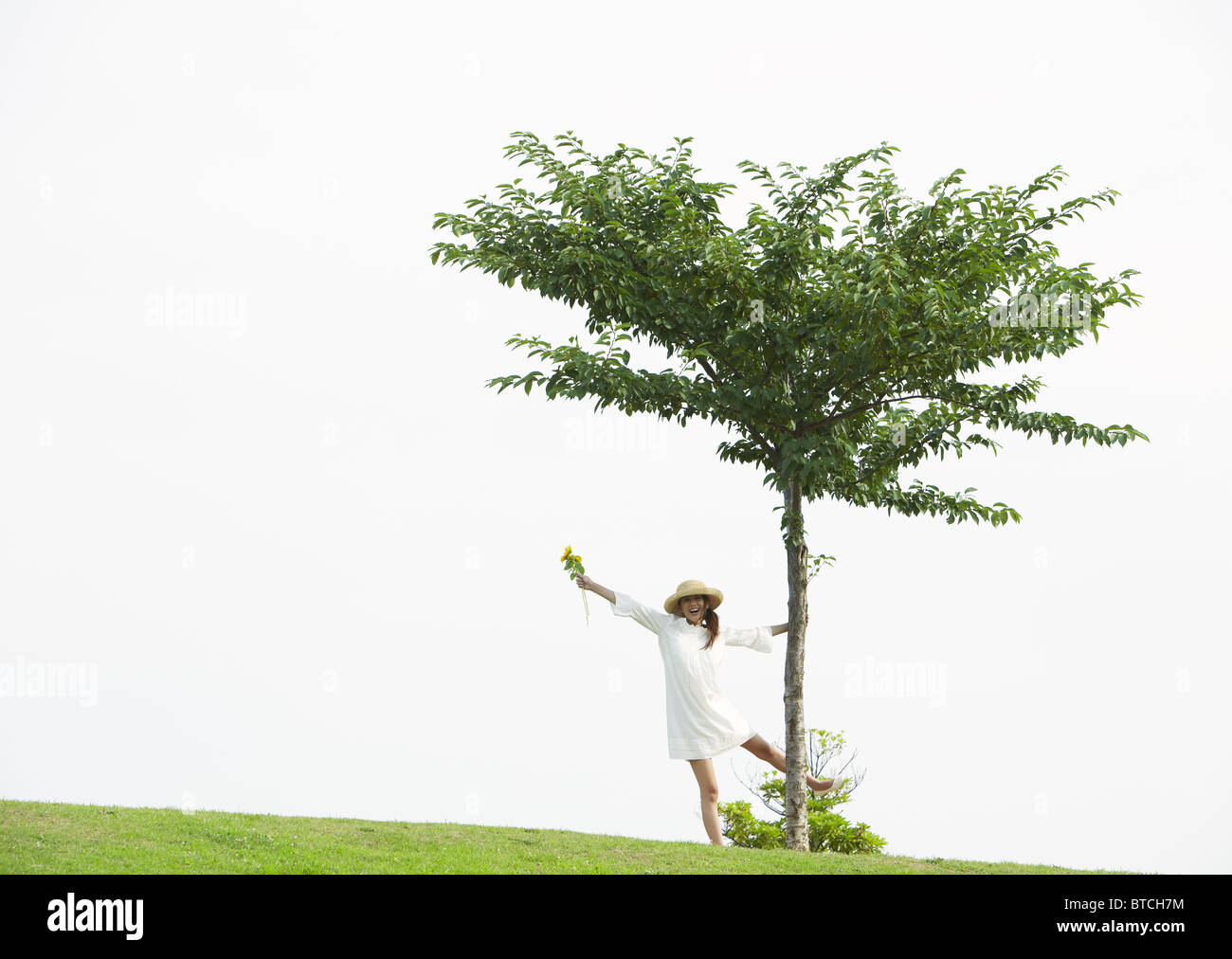 Women standing under tree hi-res stock photography and images - Alamy