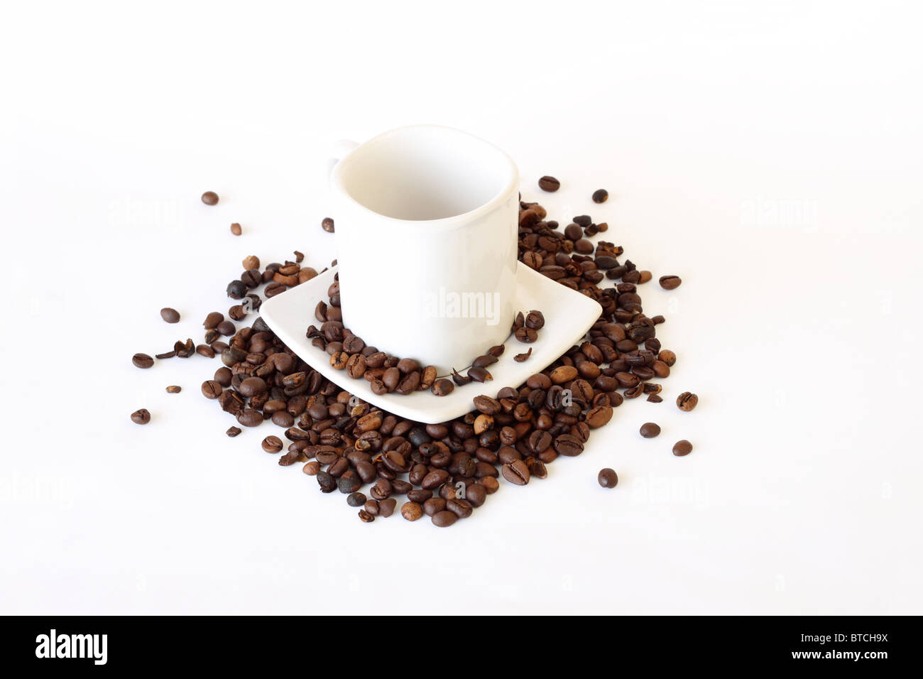coffee mug, spoon and spilled coffee on white background Stock Photo ...