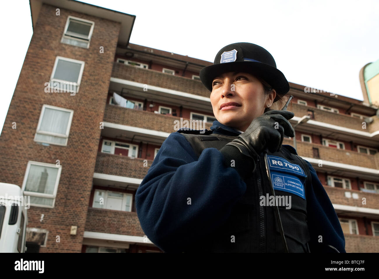Female Community Support Police Officer patrolling a block of flats in ...