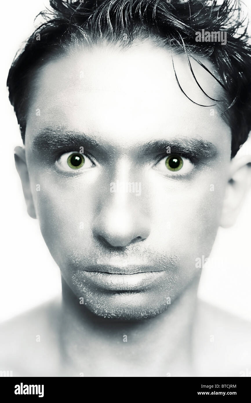 Face of a young man with a silver makeup and crazy eyes Stock Photo - Alamy