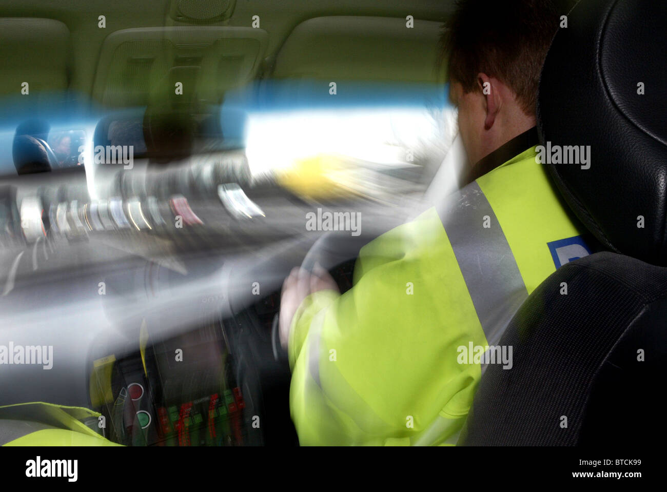 British Police Officer driving in a high speed pursuit car Stock Photo ...