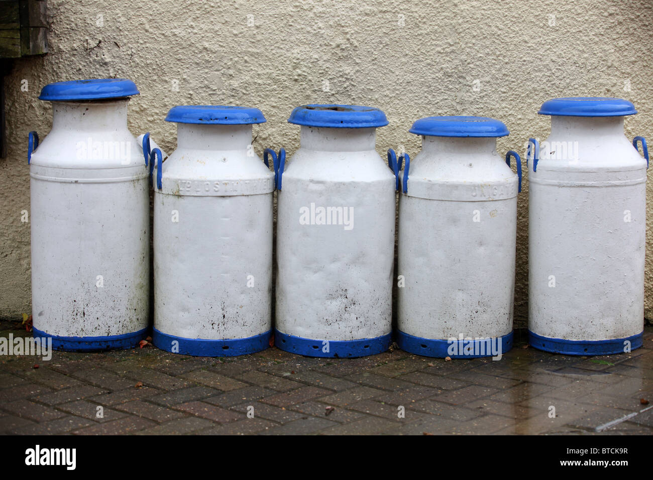 Picture of five milk churns spotted on a farm Stock Photo - Alamy