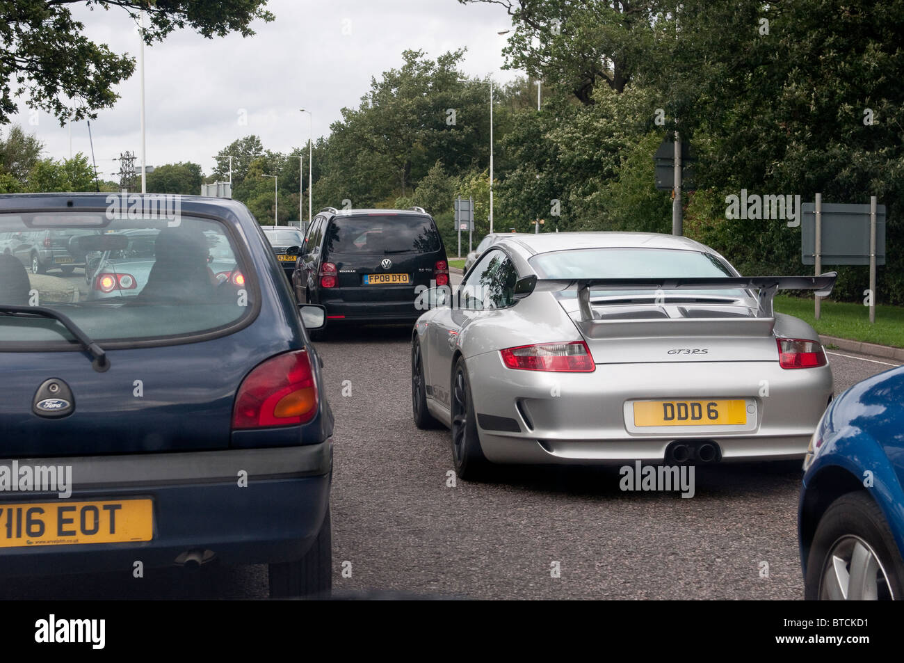 Silver Porsche GT3RS sports car stuck in traffic queues and congestion ...