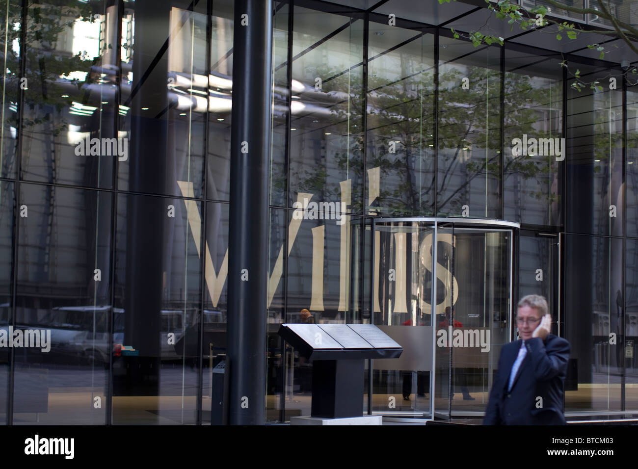 office worker walks past Willis building headquarters of Willis Group ...