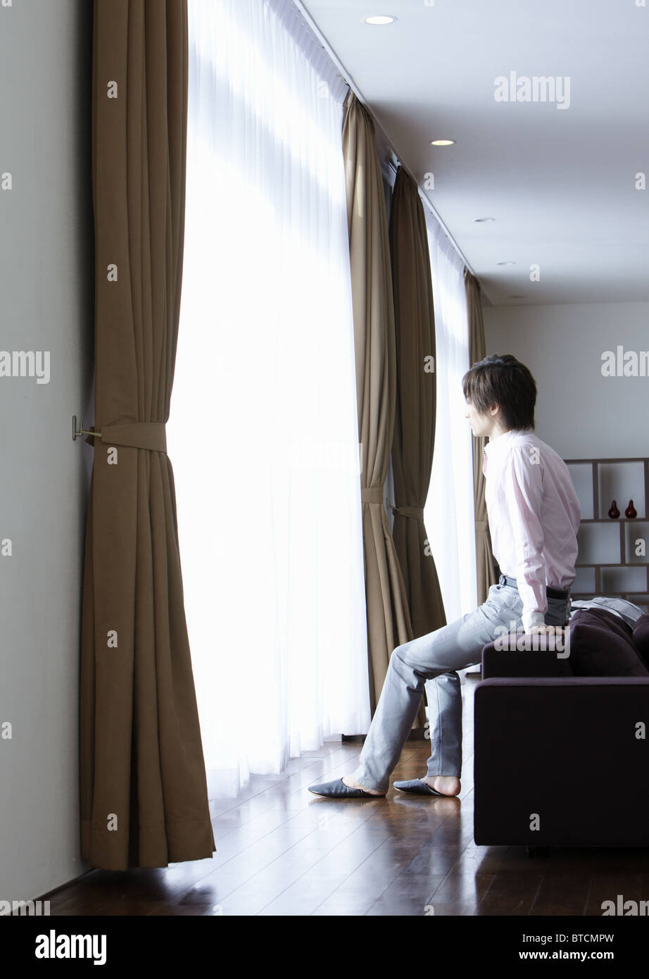 Man sitting by the window Stock Photo - Alamy