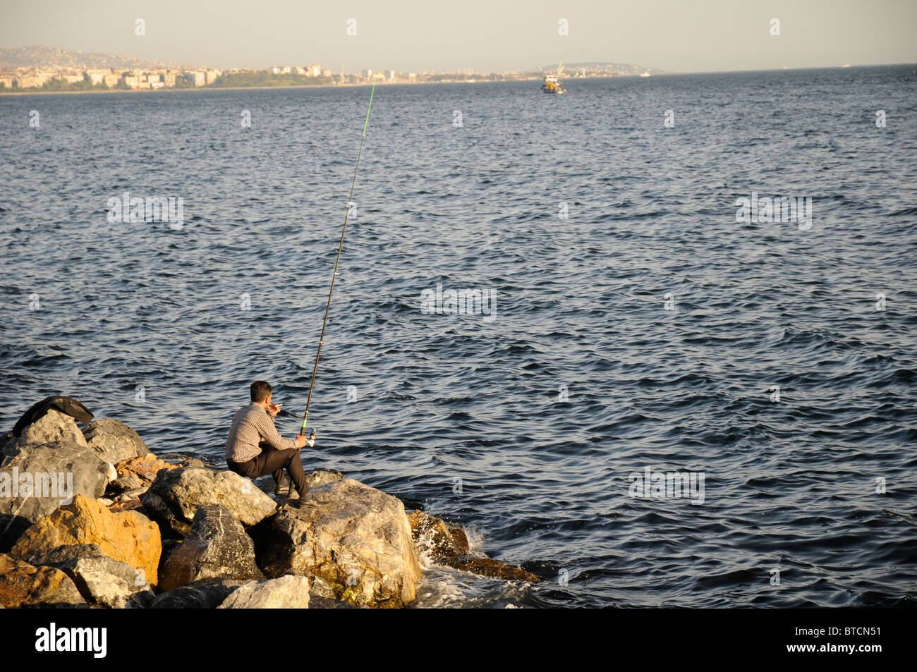 Turkish man fishing in the Bosphorus/Sea of Marmara, Istanbul, Turkey ...