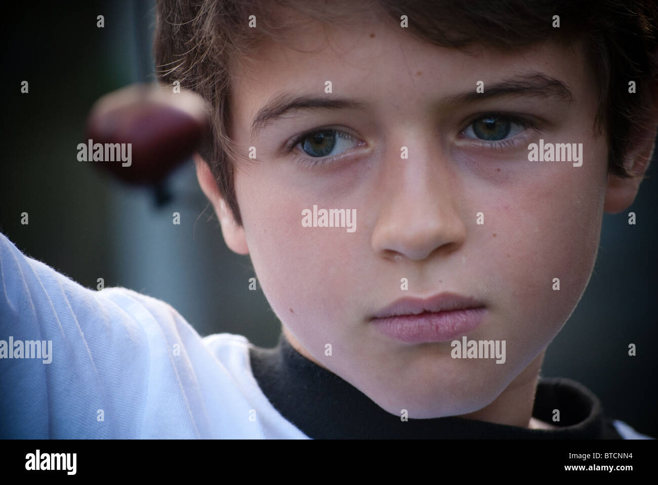 A boy holds a conker on a string for the conker game Stock Photo - Alamy