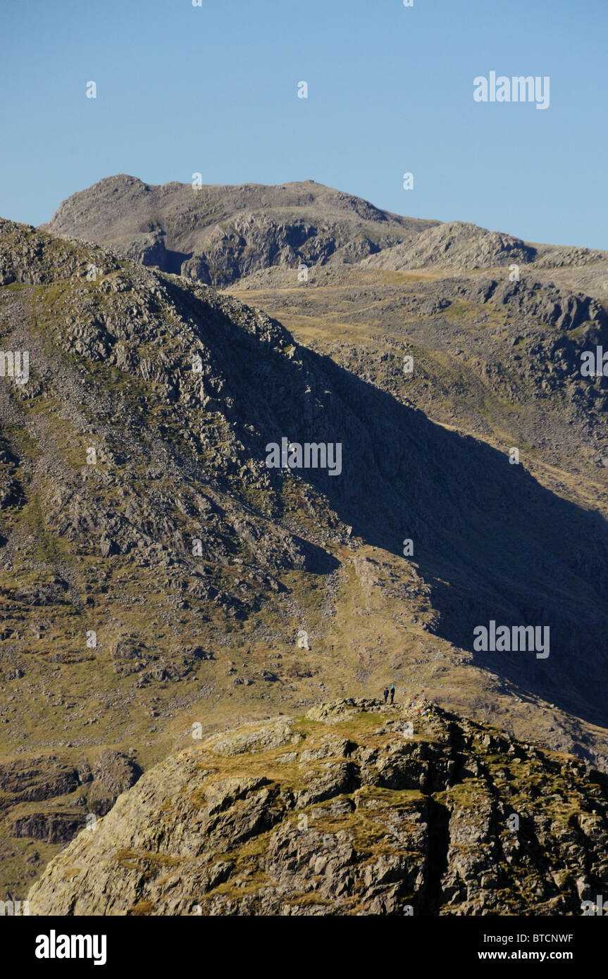 Walkers on the summit of Pike of Stickle, with Scafell Pike in the ...