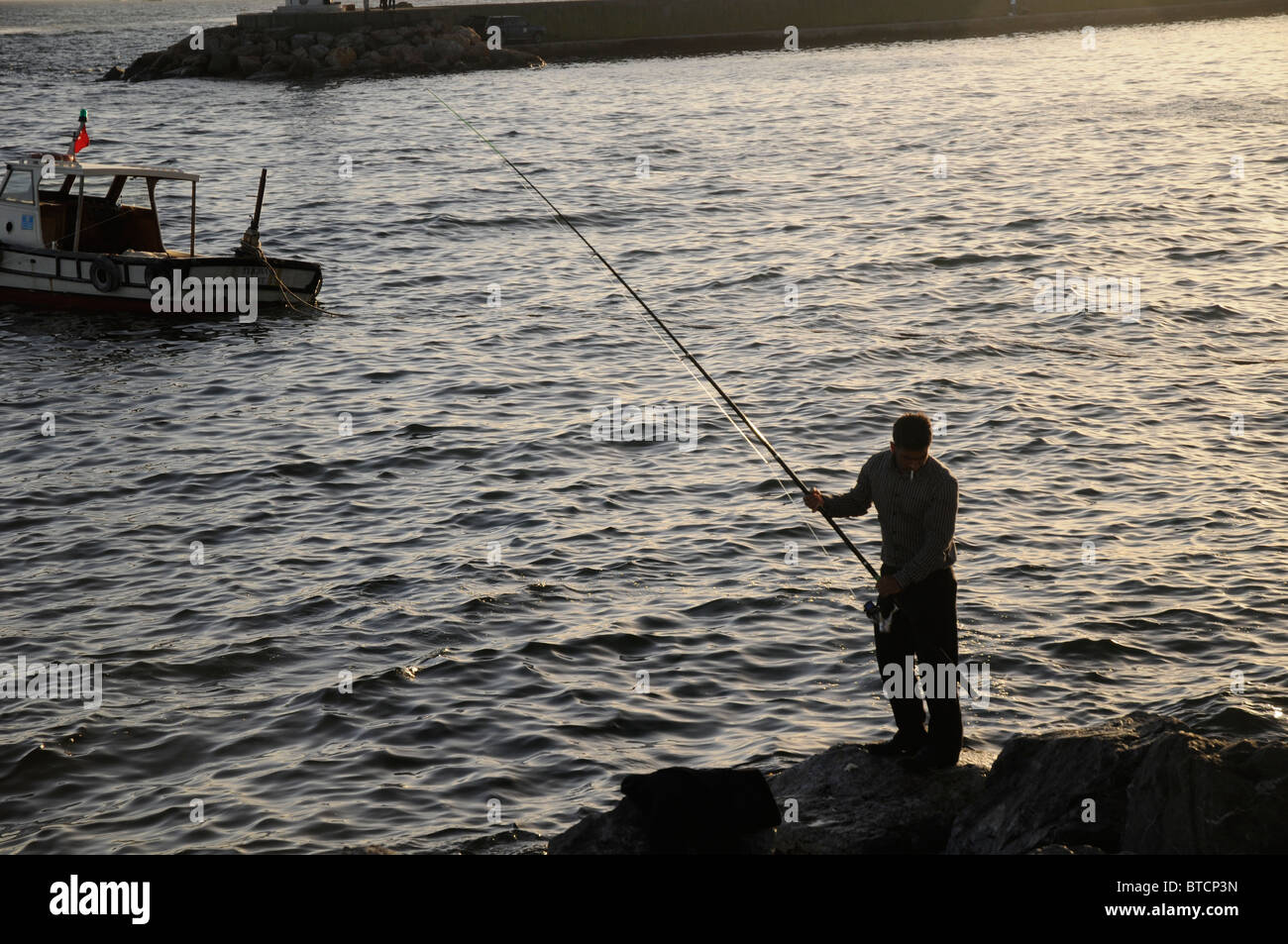 Turkish man fishing in the Bosphorus/Sea of Marmara, Istanbul, Turkey ...