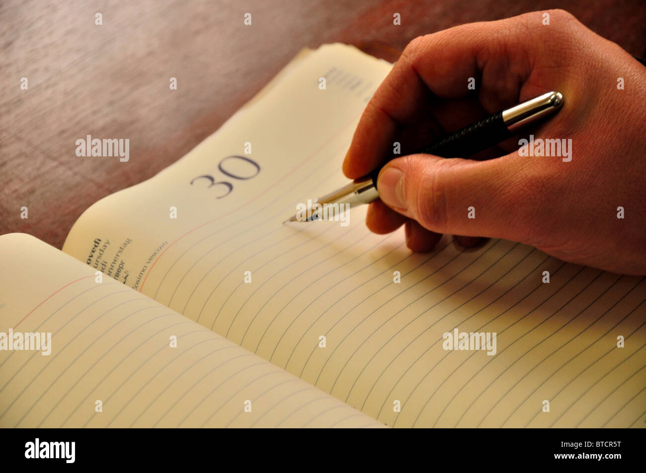 Writing on an blank page of agenda Stock Photo - Alamy