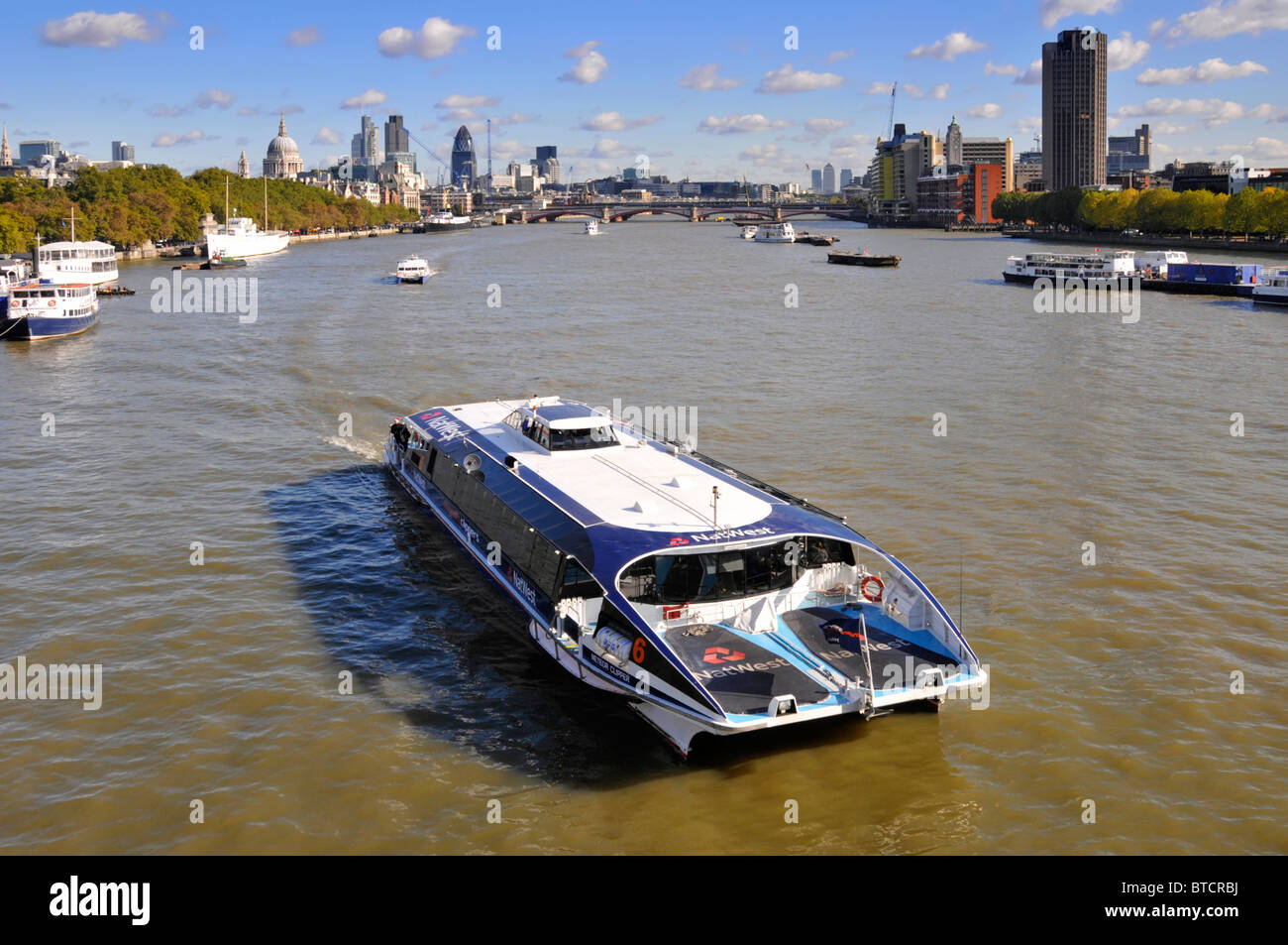 City of London skyline with River Thames fast passenger Clipper boat ...