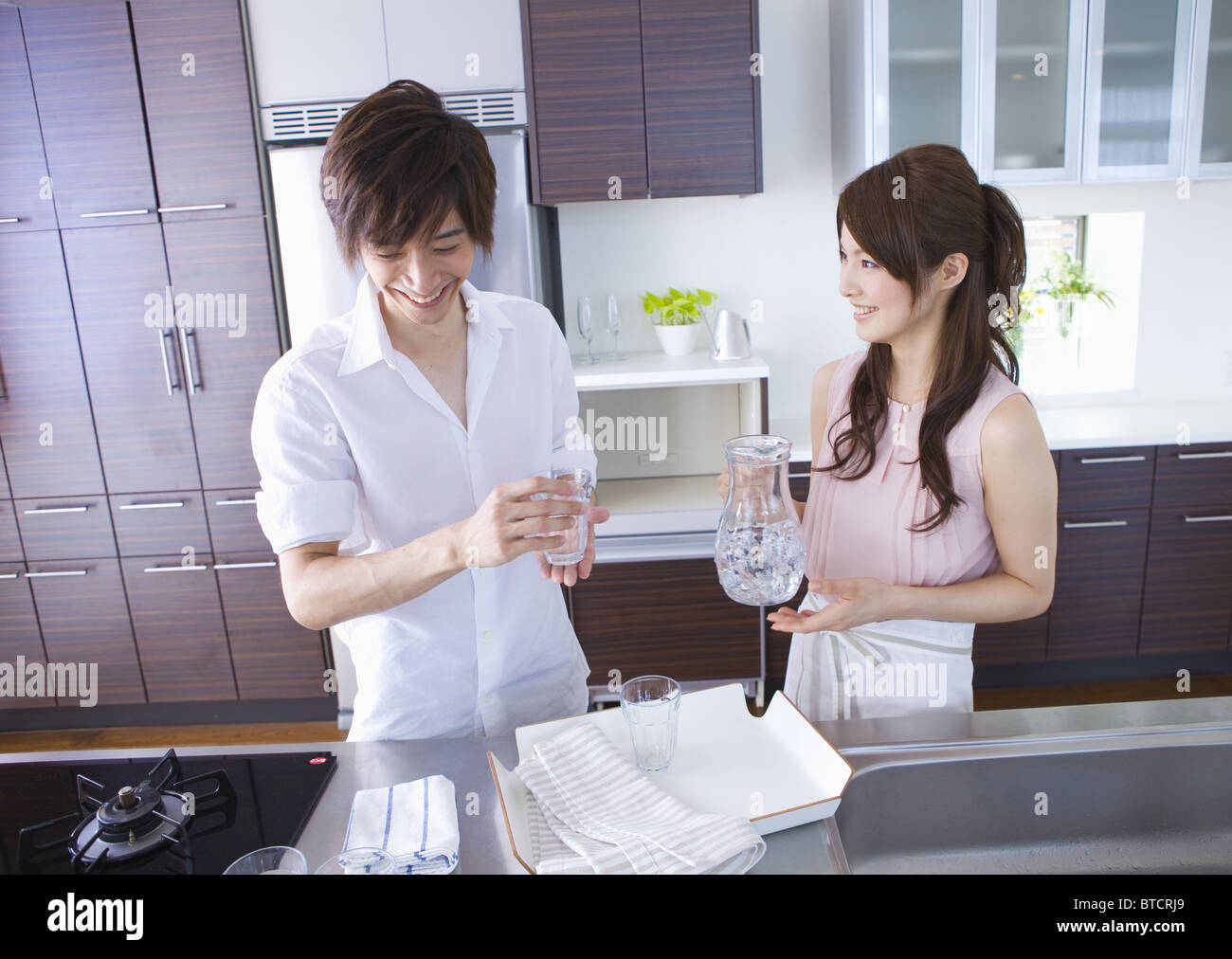 Couple standing in kitchen Stock Photo - Alamy