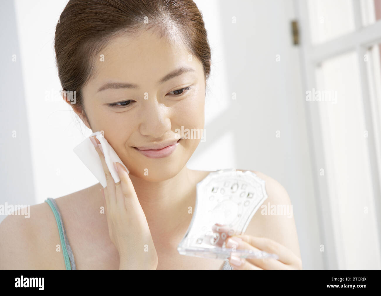Woman caring for her face Stock Photo - Alamy