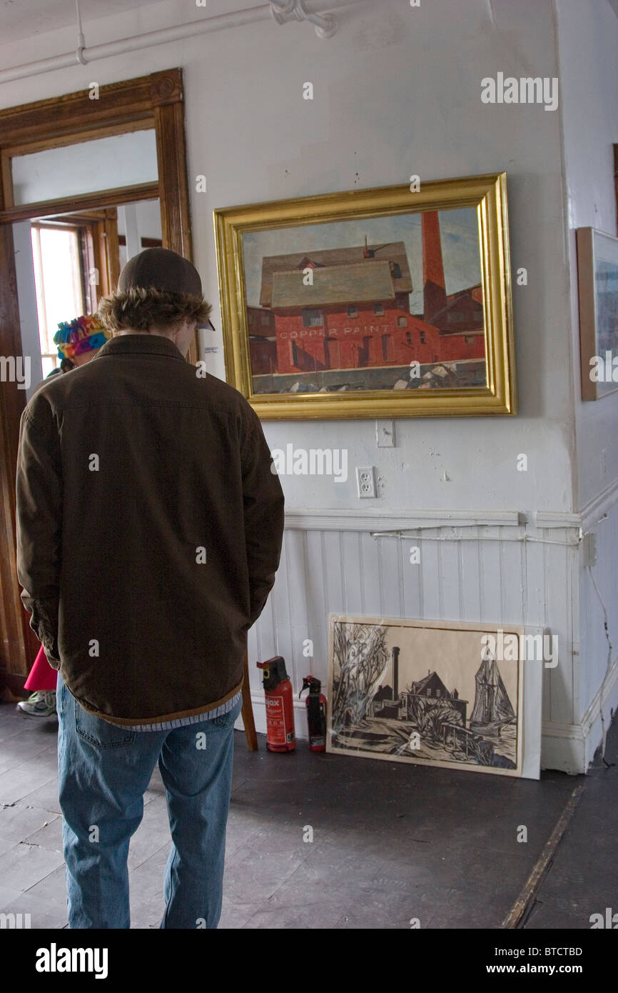 Man views art in gallery Stock Photo - Alamy