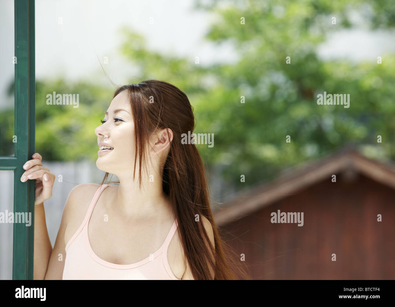 Woman standing by window Stock Photo - Alamy