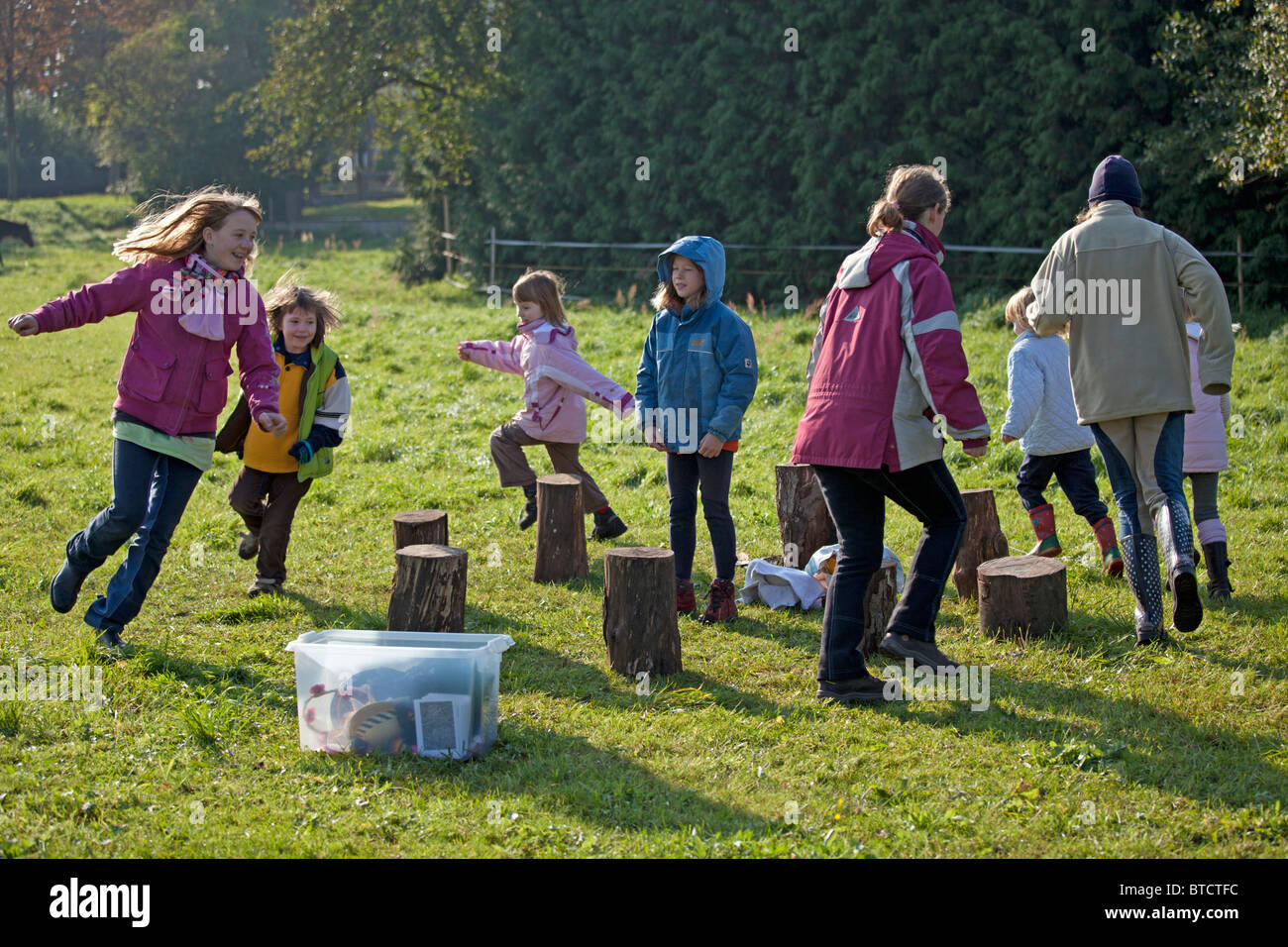 young girls playing a game and running in a circle on a meadow Stock ...