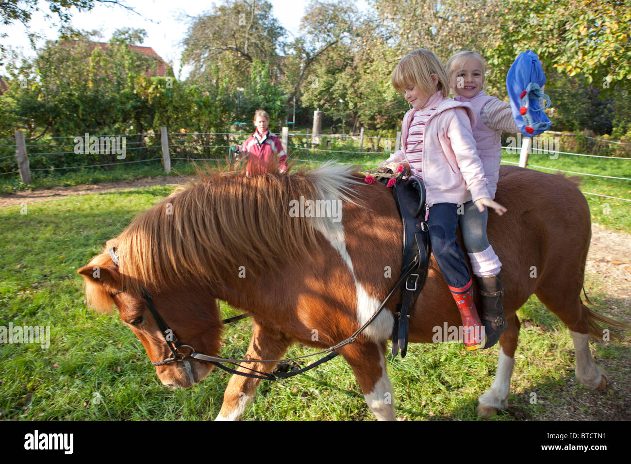 Woman leading child pony hi-res stock photography and images - Alamy