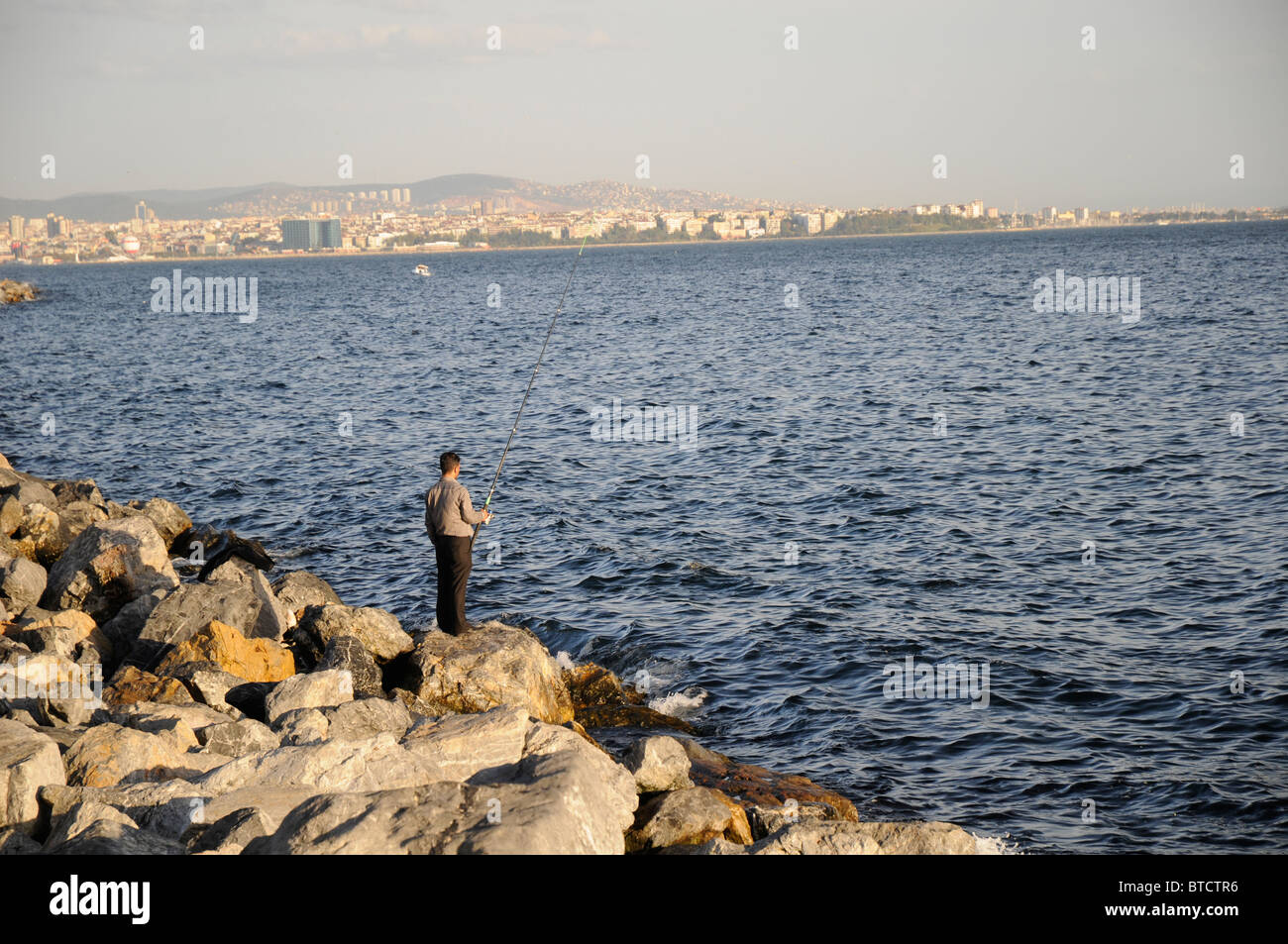 Turkish man fishing in the Bosphorus/Sea of Marmara, Istanbul, Turkey ...