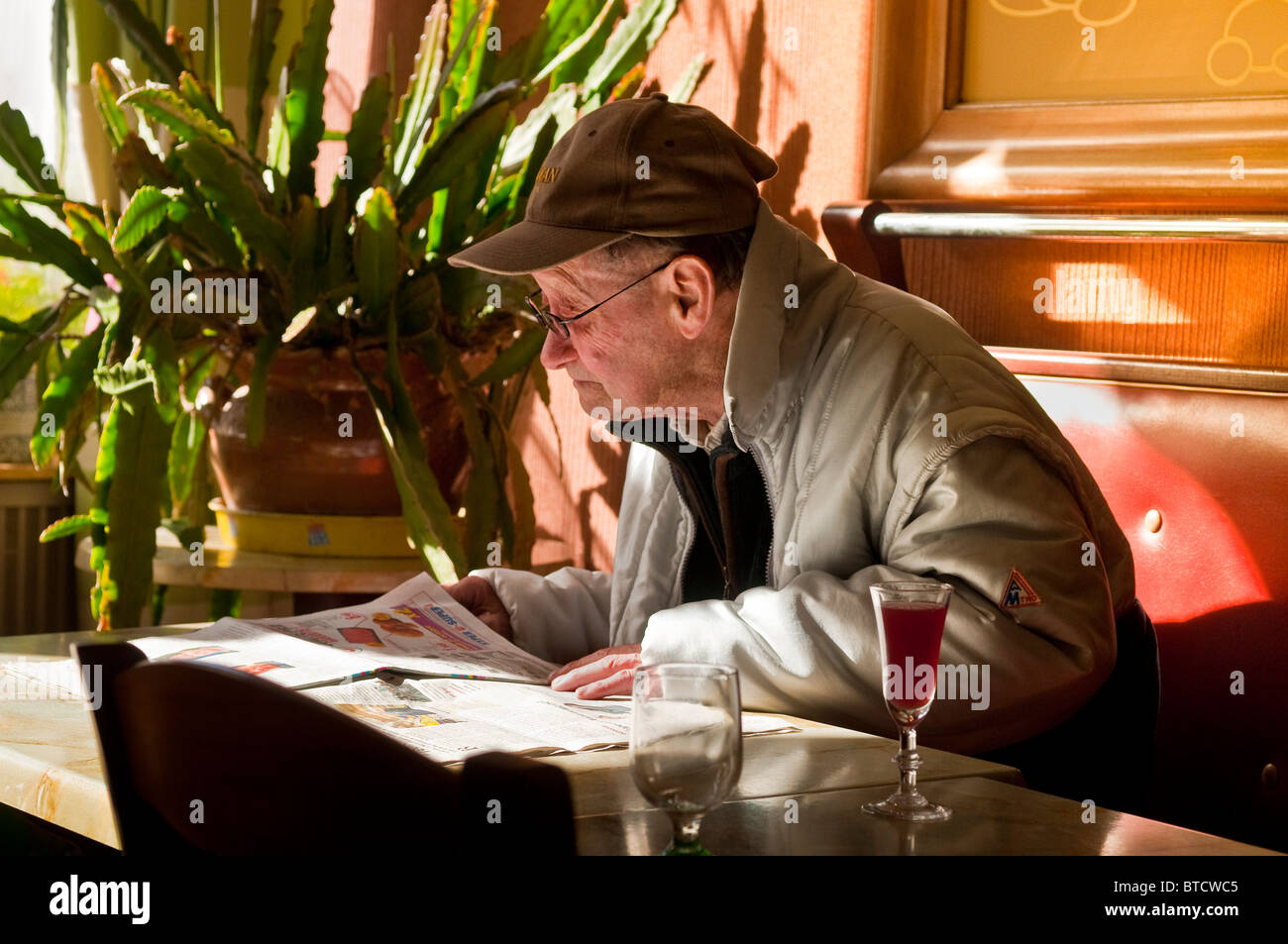 Old man reading newspaper in French bar - France Stock Photo - Alamy