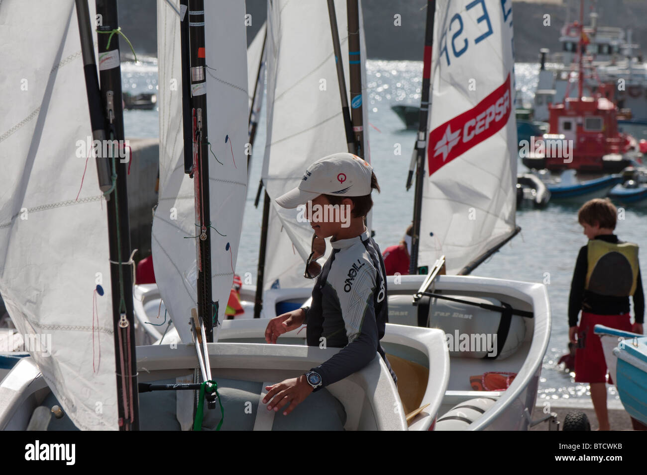 Getting ready to take part in a regatta of Optimist sailing dinghies in ...