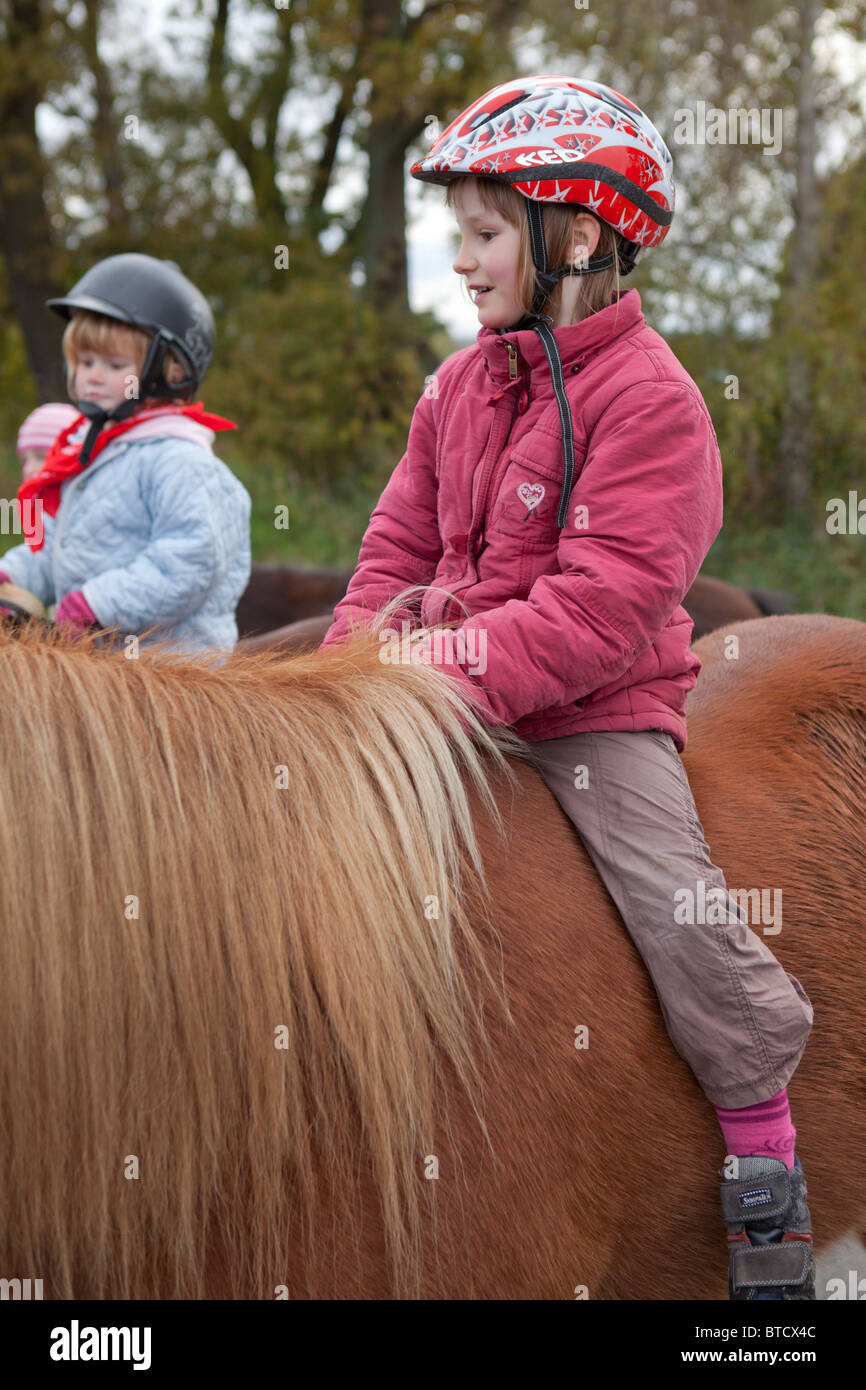 small girls riding a ponies Stock Photo - Alamy