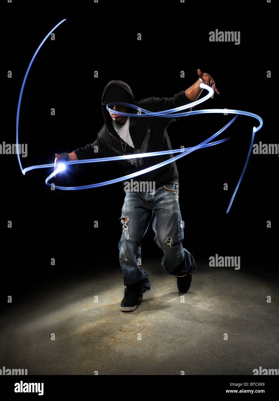 African American hip hop dancer with LED lights painting patterns Stock ...