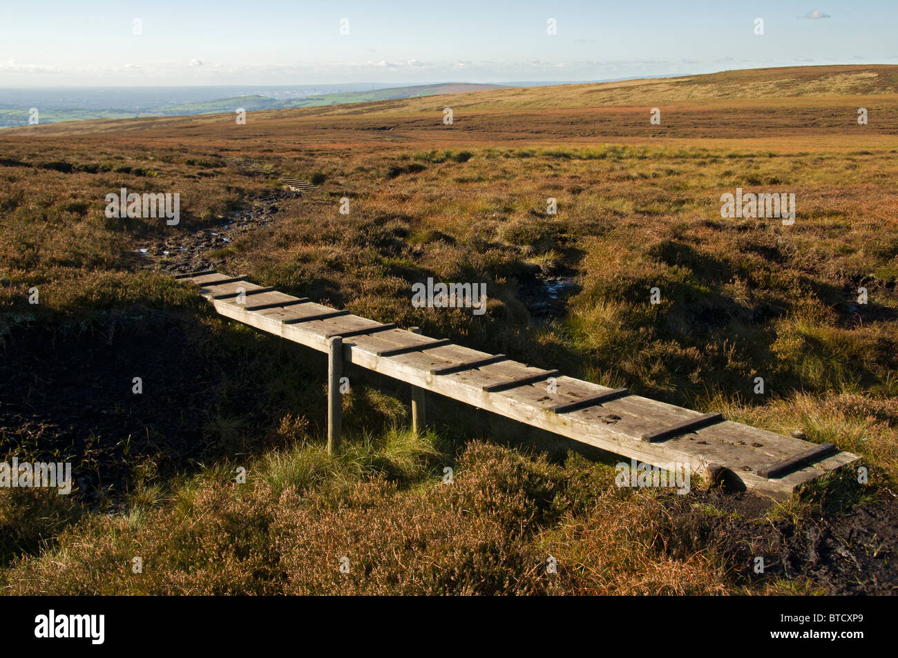 Small boardwalk bridge over a peat grough (gully) on Bleaklow hill ...