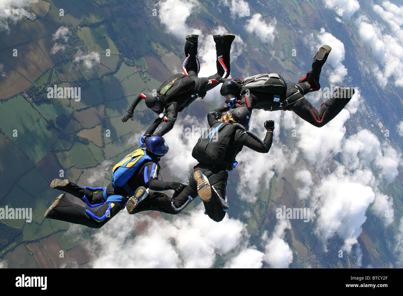 Four skydivers in action Stock Photo - Alamy