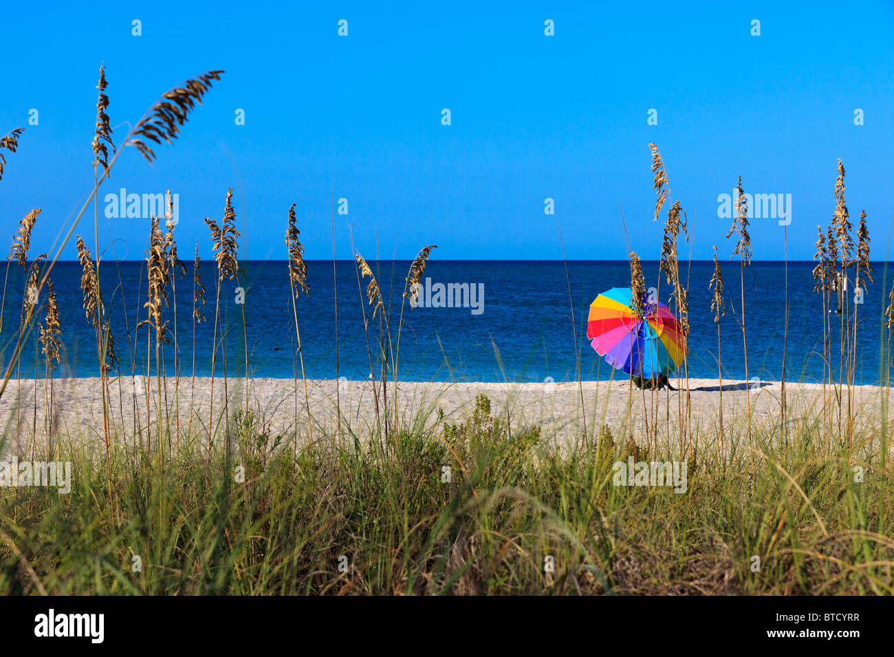 Under a beach umbrella Stock Photo - Alamy