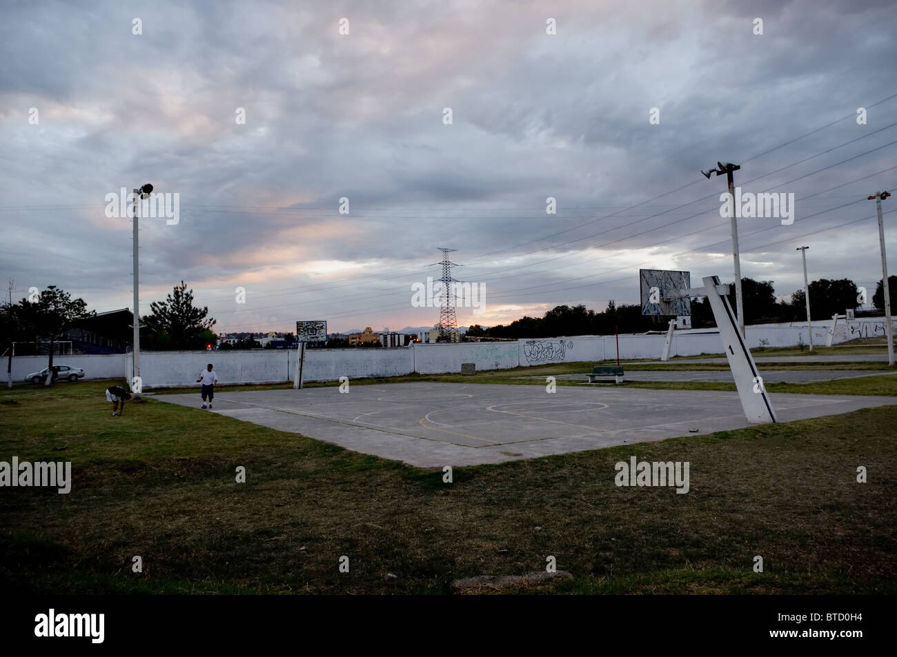 Basketball court in a park during sunset Stock Photo - Alamy