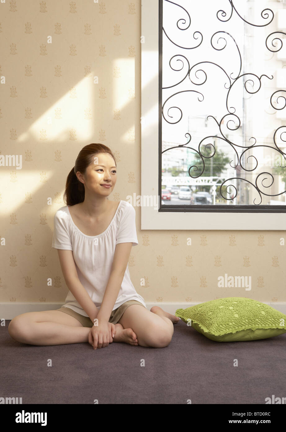 Woman sitting by the window Stock Photo - Alamy