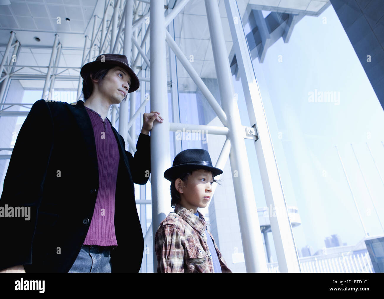 Father and son looking out the window Stock Photo - Alamy