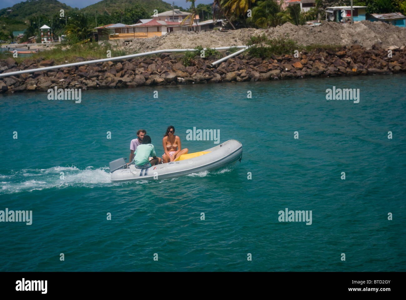 three persons in dingy Stock Photo - Alamy
