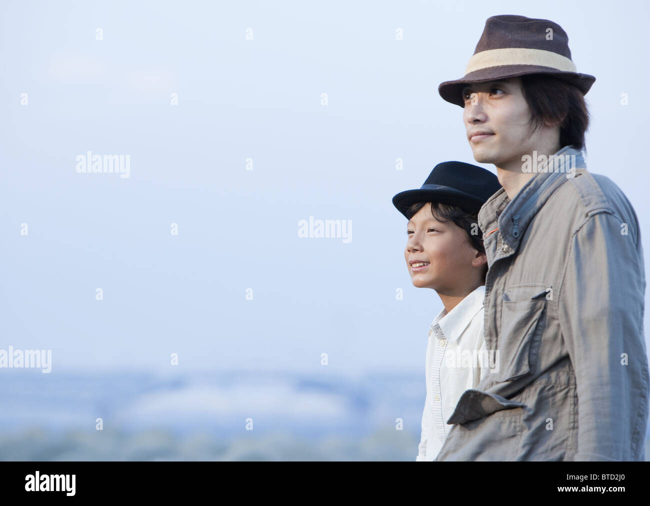 Father and son looking away Stock Photo - Alamy