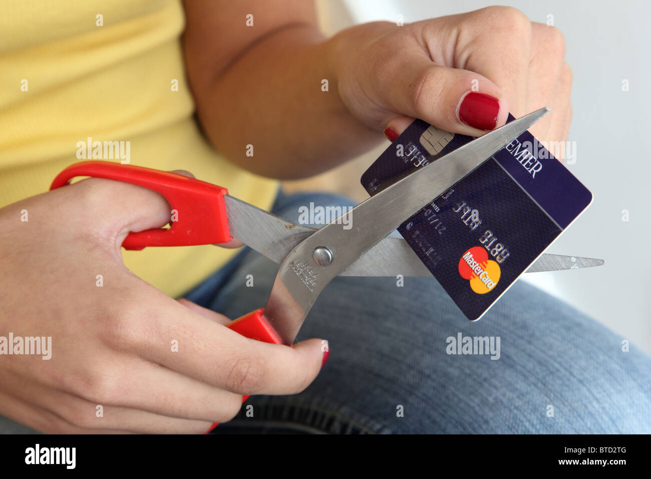 Closeup of caucasian hands cutting up credit card hi-res stock ...