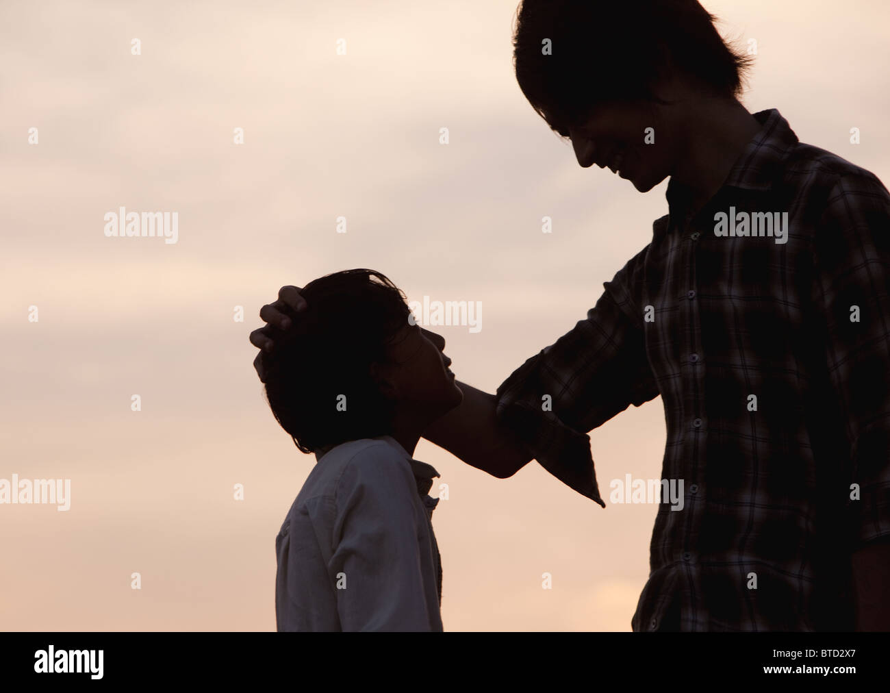 Father stroking sons head Stock Photo - Alamy